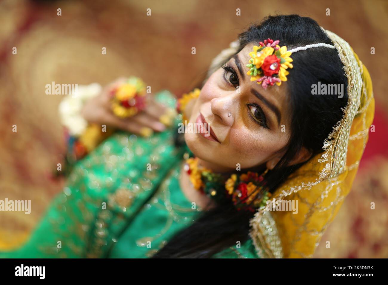 Bride at Traditional Mayoon ceremony at colorfully decorated venue in ...