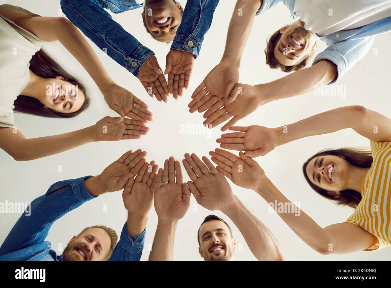 Team of happy smiling diverse friends joining their hands to show concept of teamwork Stock ...