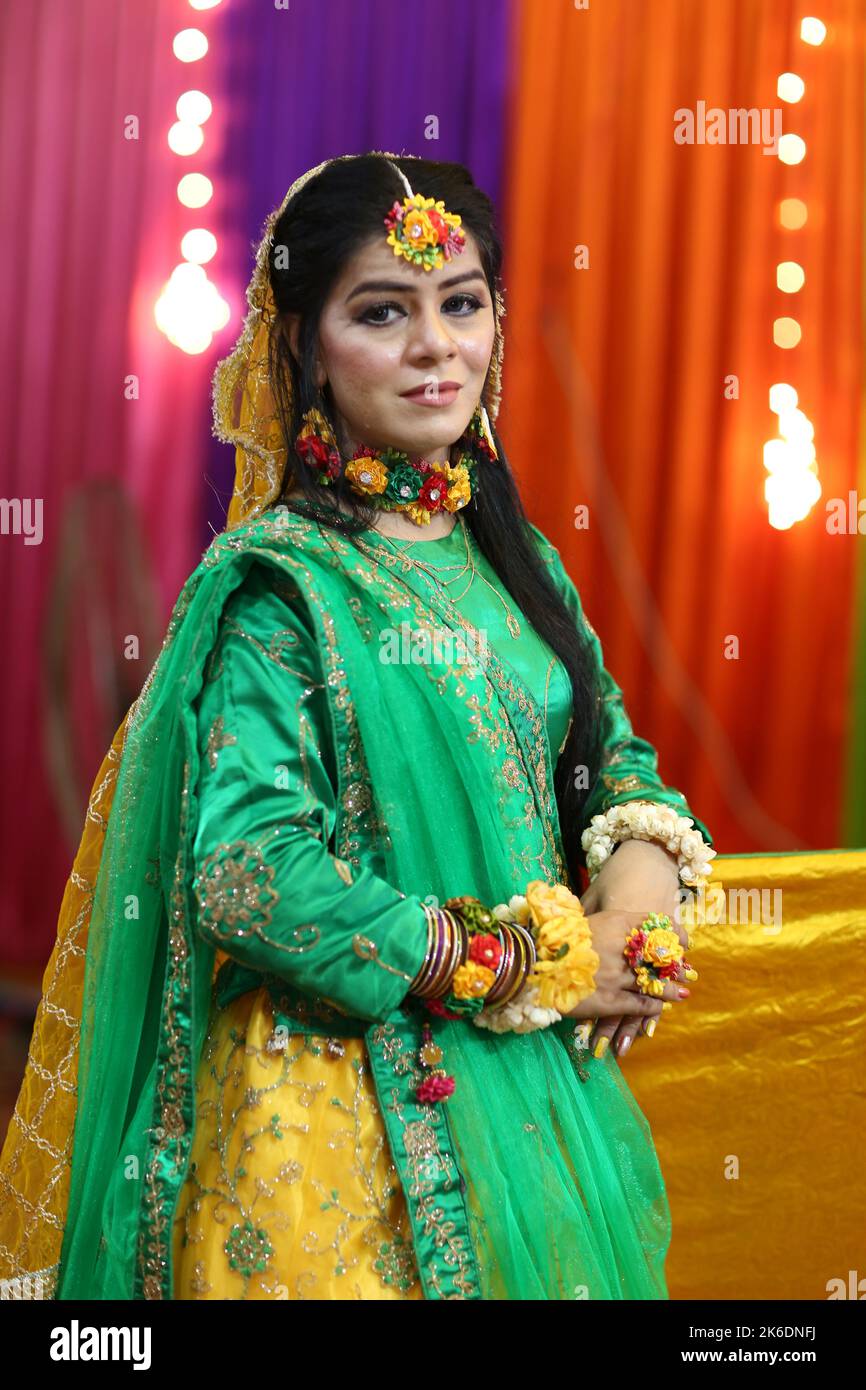 Bride at Traditional Mayoon ceremony at colorfully decorated venue in ...