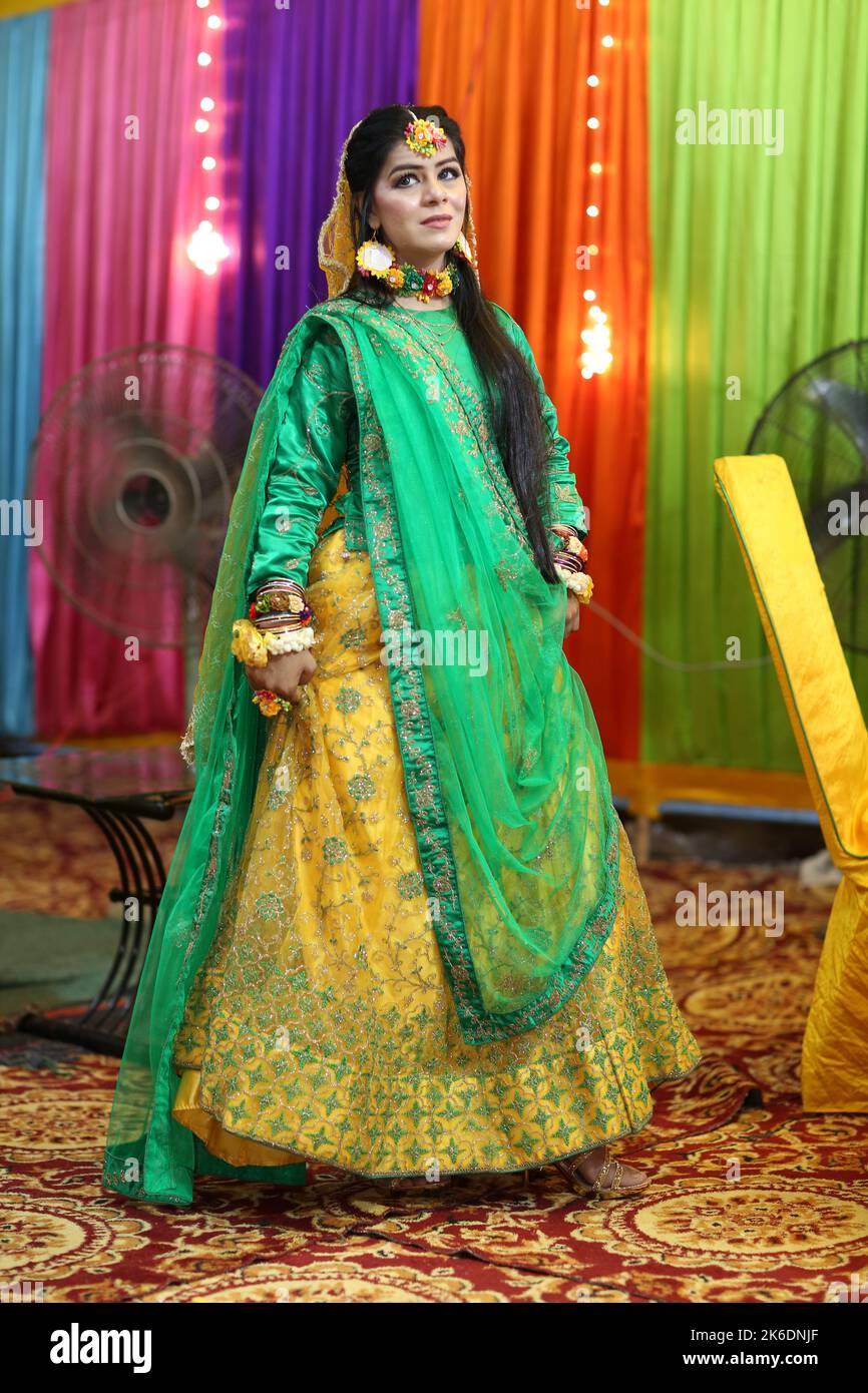 Bride at Traditional Mayoon ceremony at colorfully decorated venue in ...