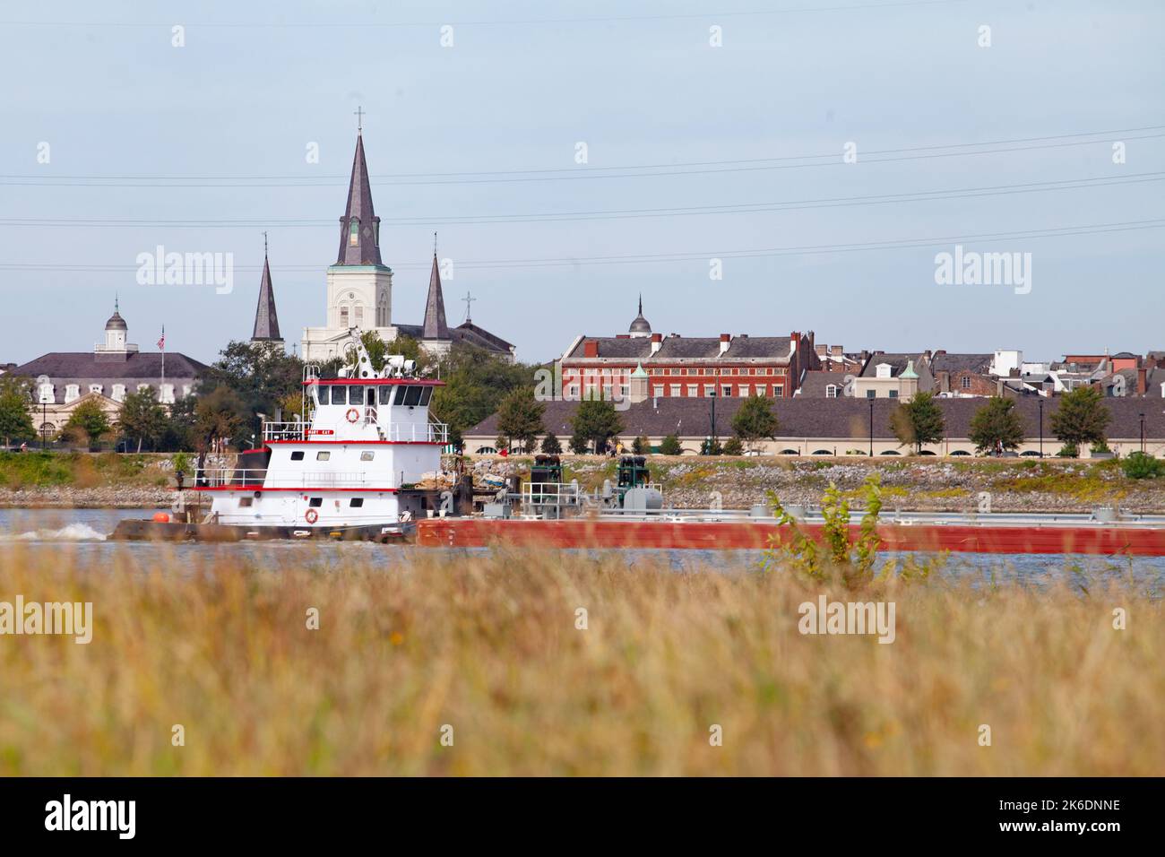 The mv. Mary Kay pushes a tow of barges downriver past New Orleans, La ...