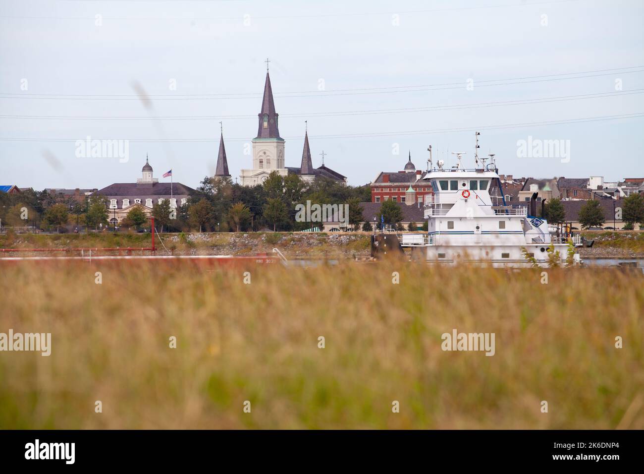The mv. Point Mallard pushes a tow of barges upriver past the French ...