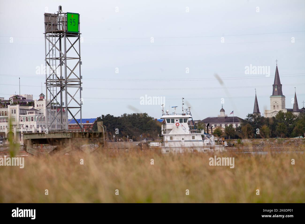 The mv. Point Mallard pushes a tow of barges upriver past the French ...