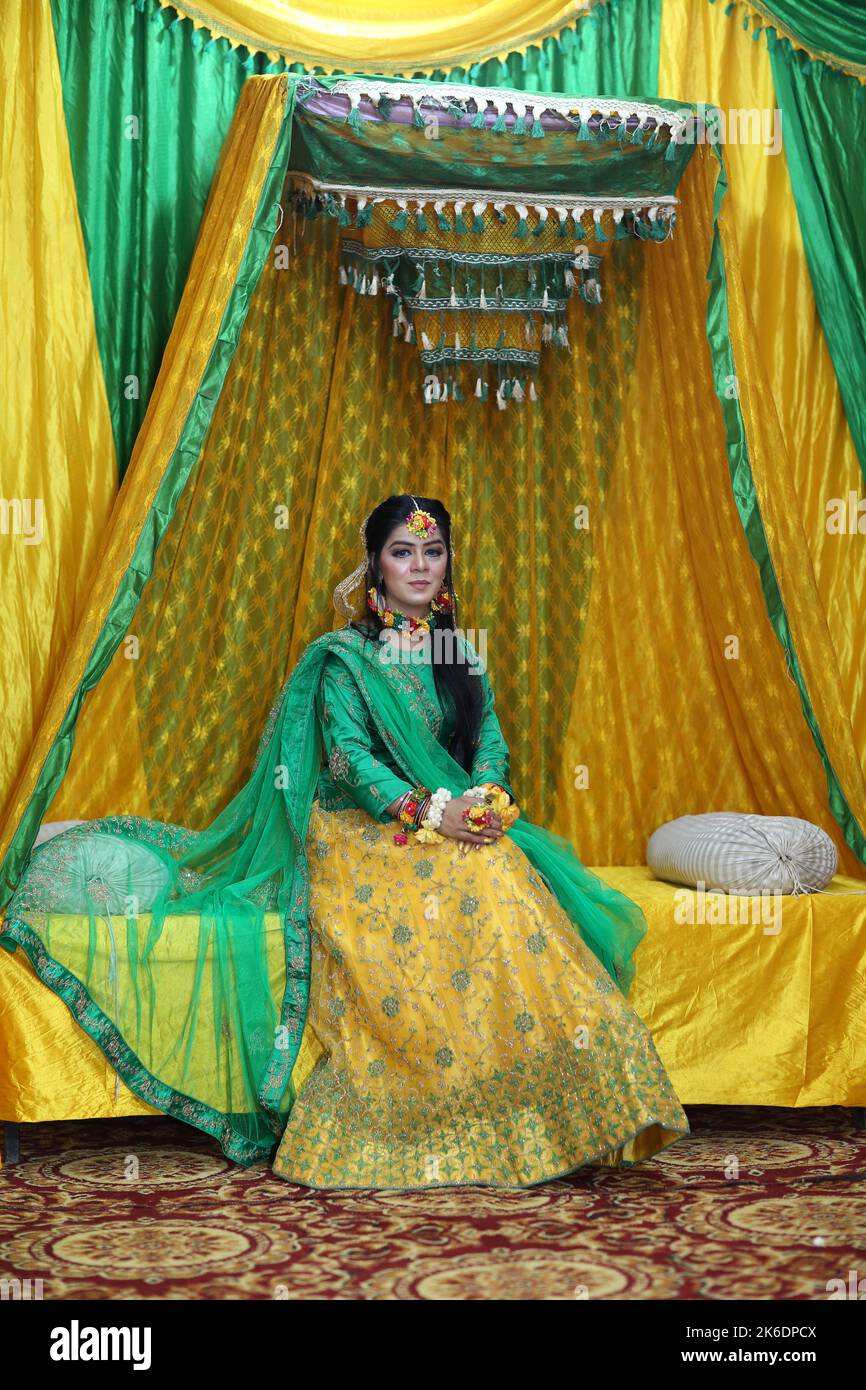 Bride at Traditional Mayoon ceremony at colorfully decorated venue in ...