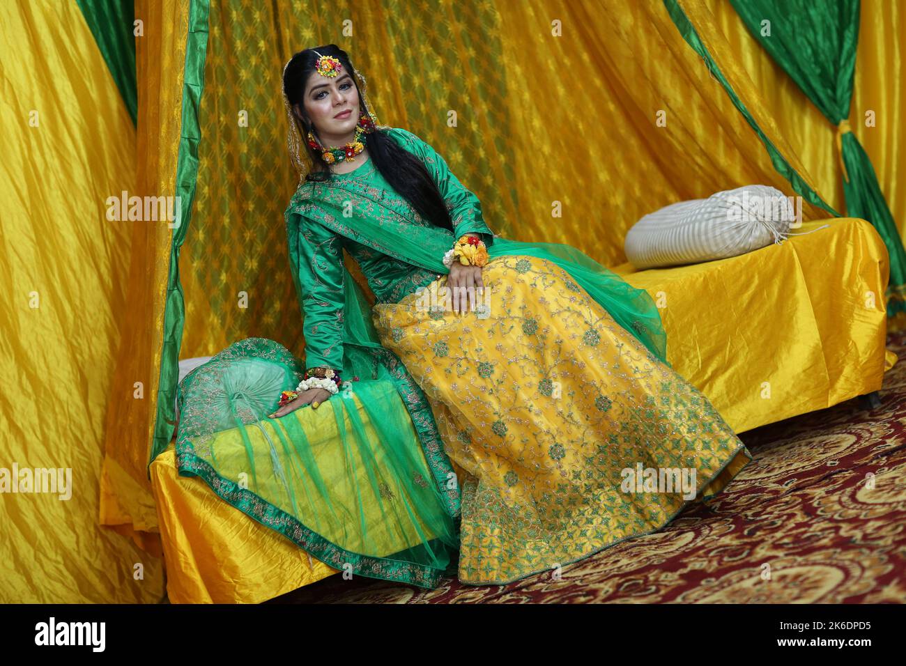 Bride at Traditional Mayoon ceremony at colorfully decorated venue in ...