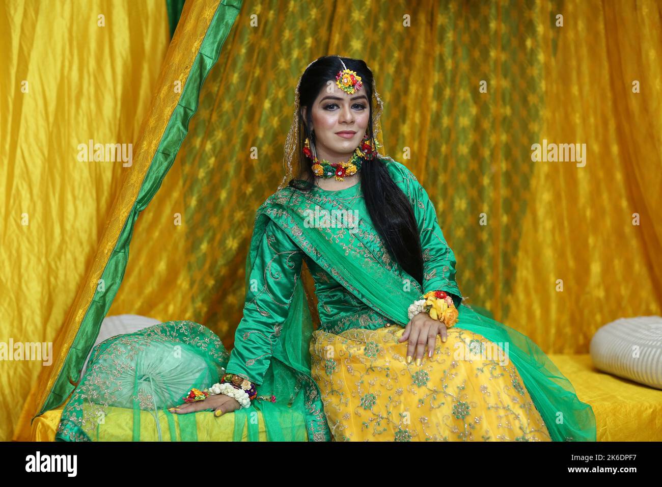 Bride at Traditional Mayoon ceremony at colorfully decorated venue in ...