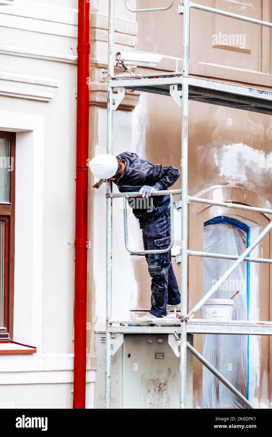 Renovation, restoration, refurbishment. Unrecognizable worker renovating wall of classical style ...
