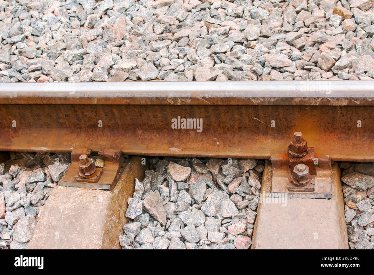 Rail rails on sleepers with bolts and nuts Stock Photo - Alamy