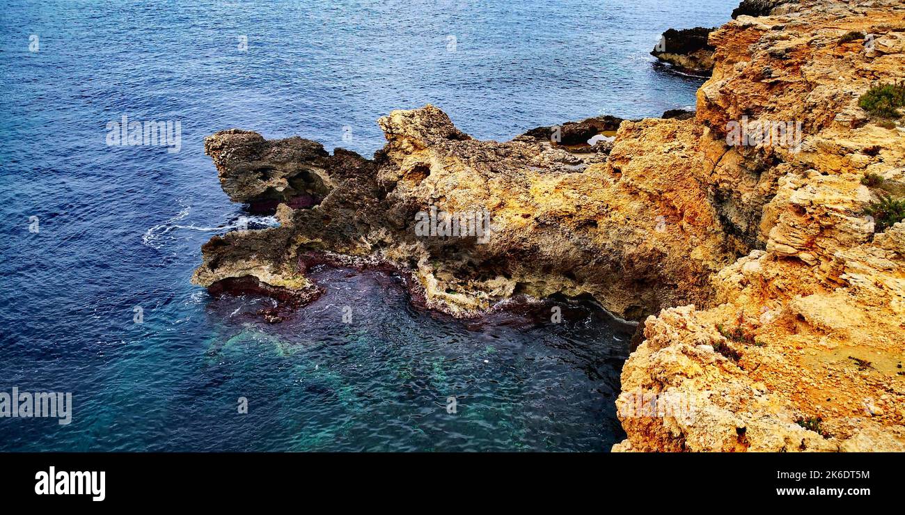 A rock shore along a hiking trail at Marfa Ridge in Malta Stock Photo ...