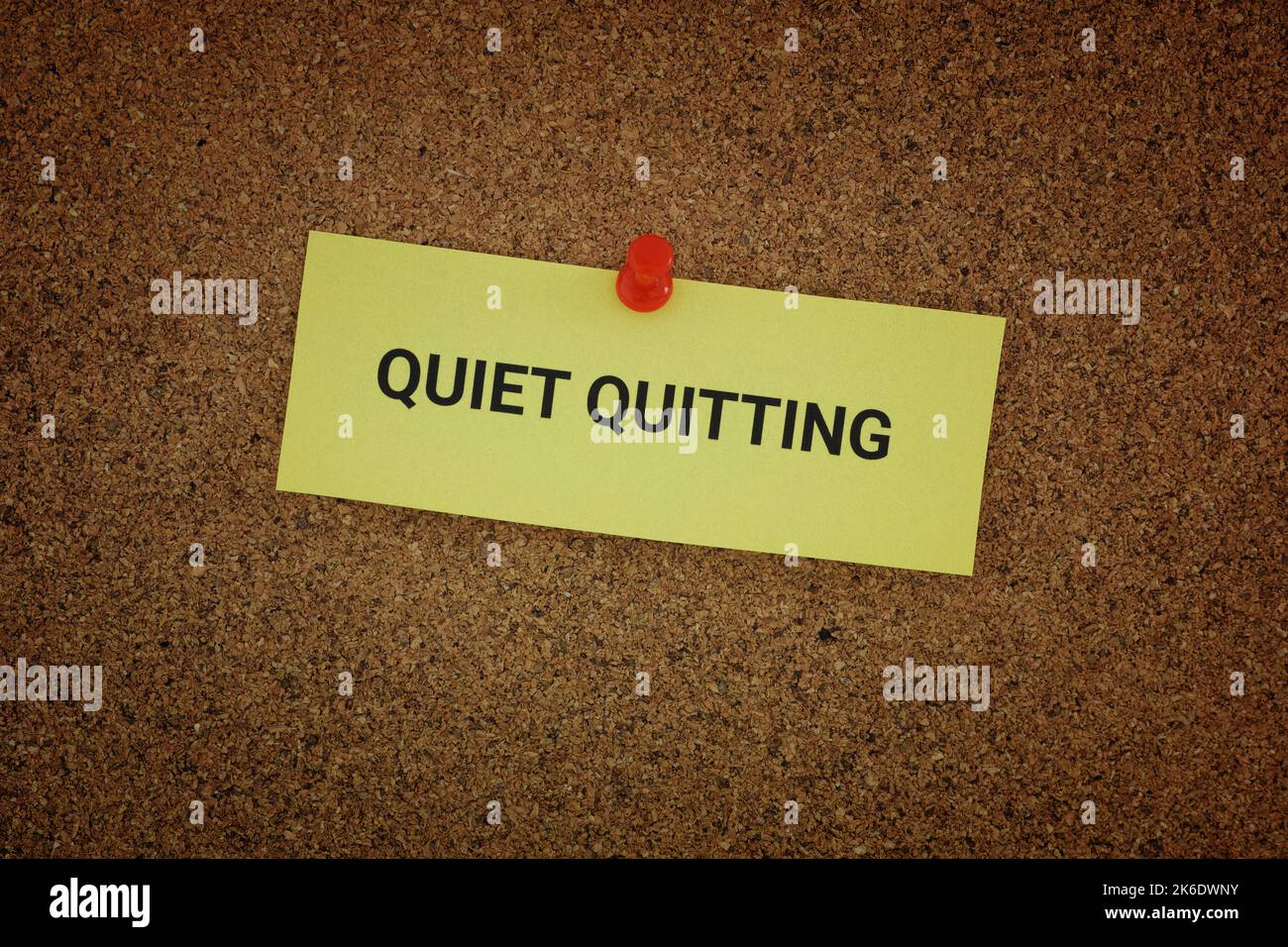 A yellow paper note with the words Quiet Quitting on it pinned to a ...