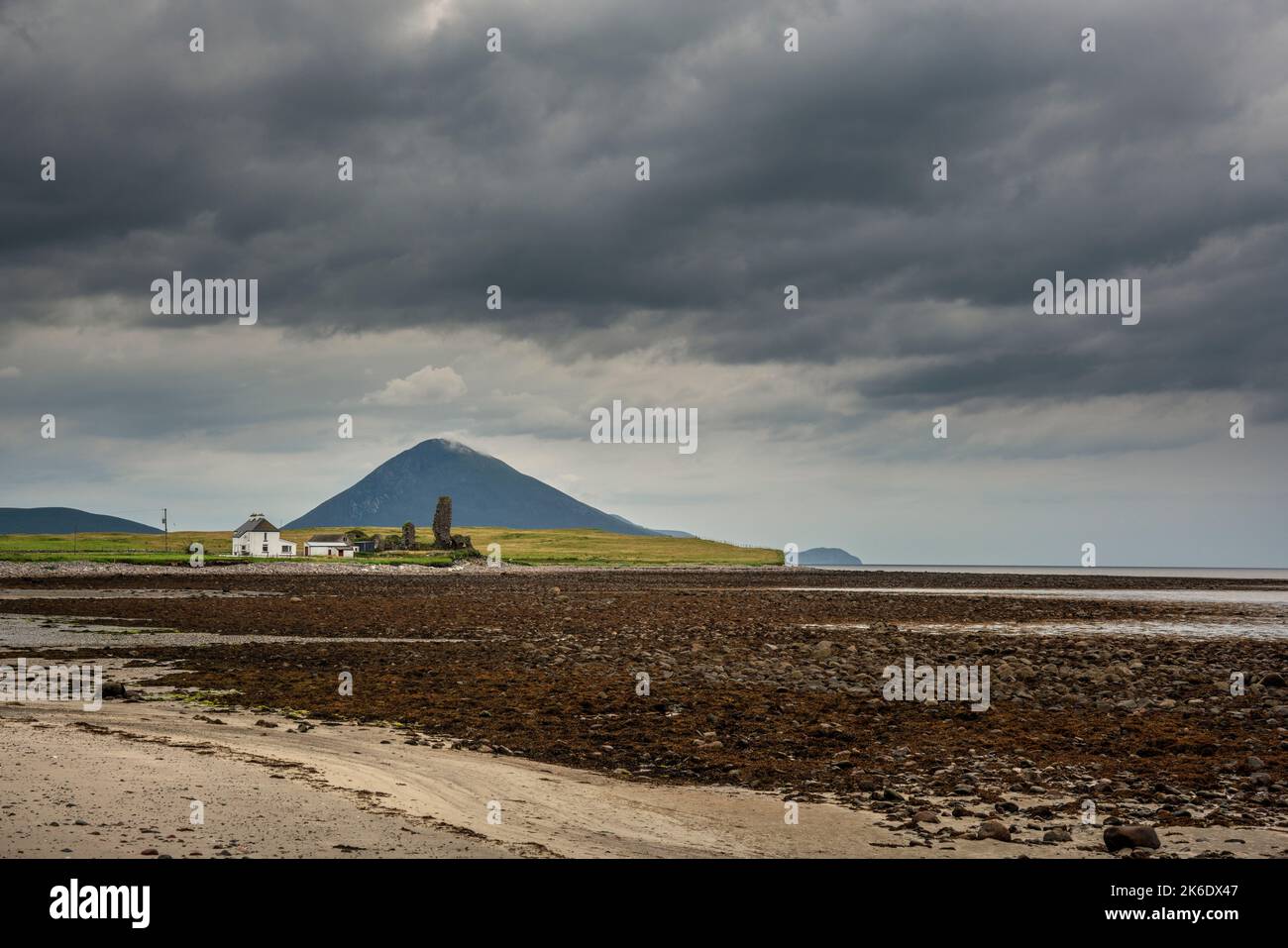 Ruins of Fahy Castle at Tullaghan Bay, seen from Doona Beach at low ...