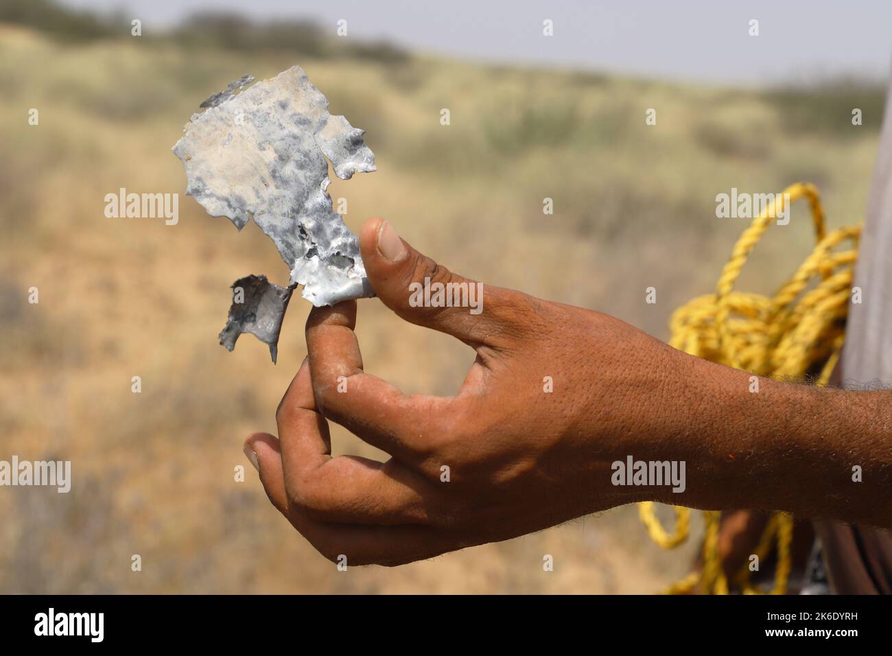 Abs, Yemen. 13th Oct, 2022. A farmer holds a piece of shrapnel from an ...