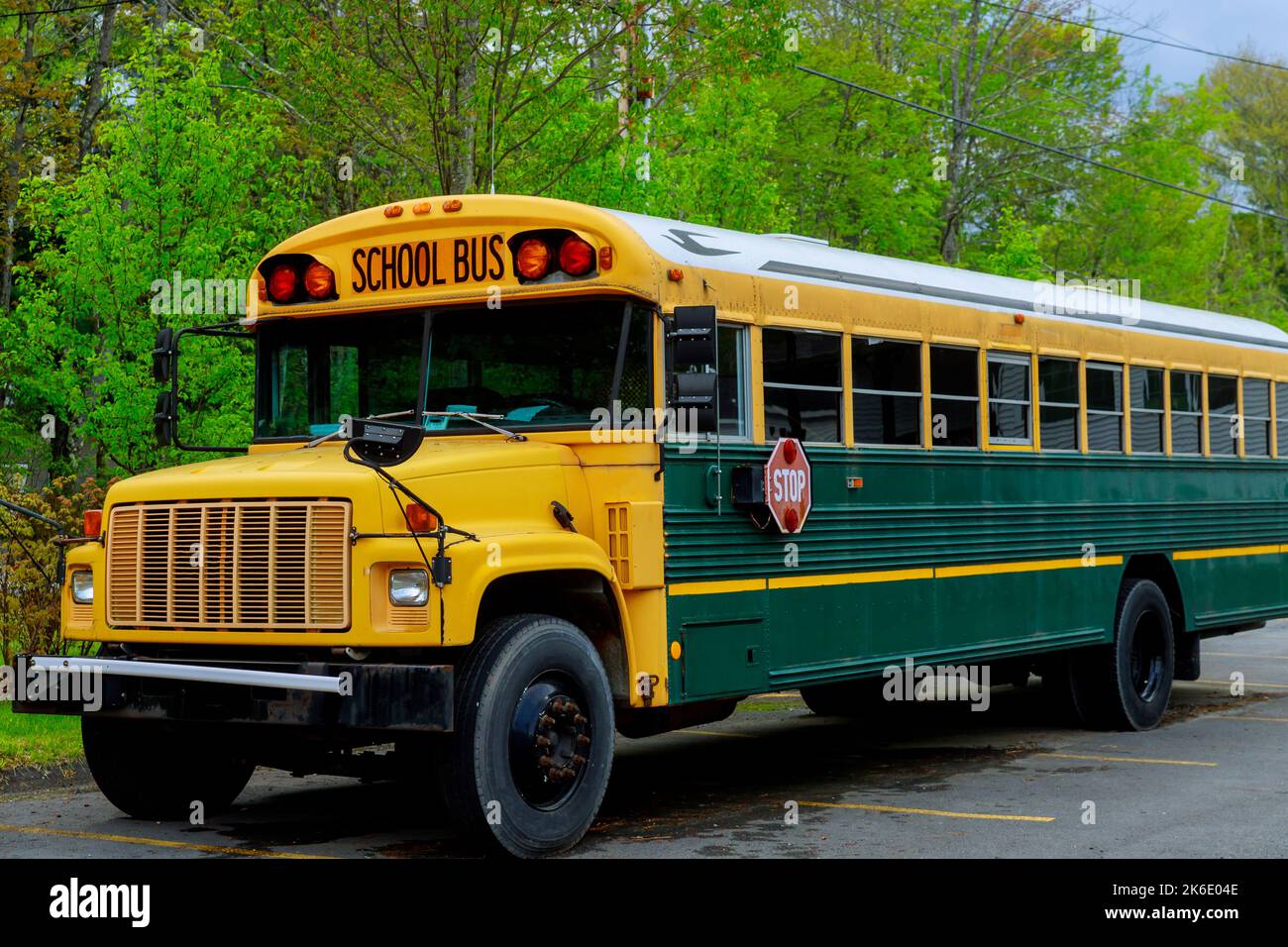 Traditional school bus on road transports children to school every day ...