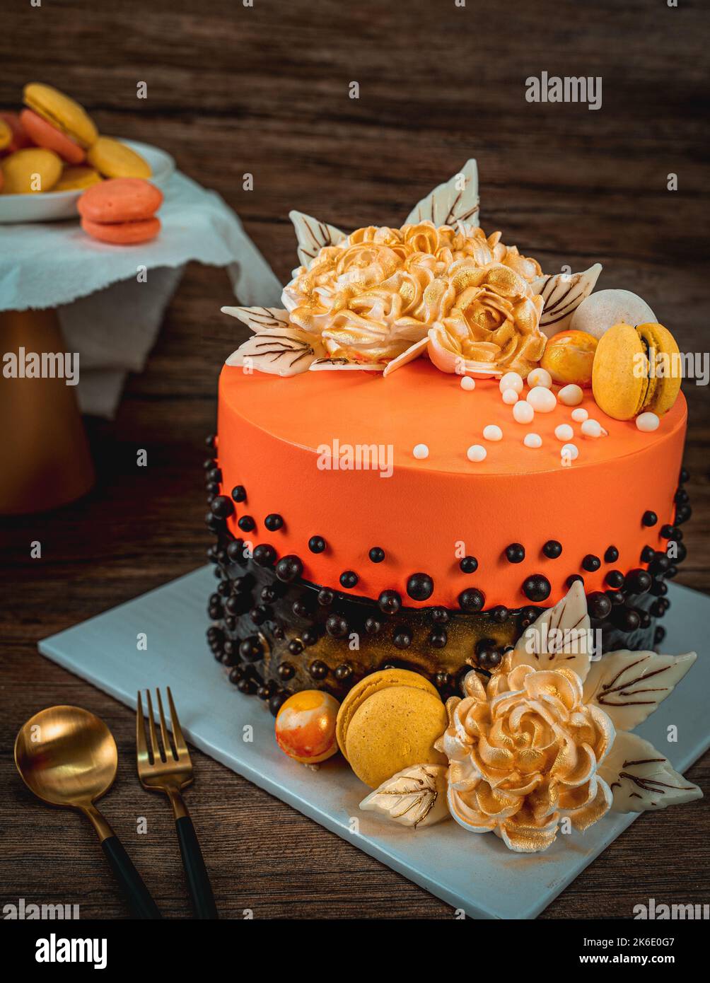 An orange cake decorated with golden flowers, vertical Stock Photo - Alamy