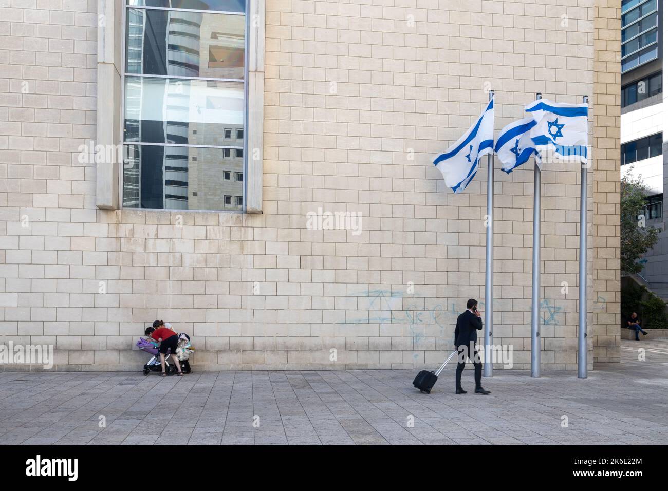 Haifa, Israel - October 14, 2022, A male clerk in office clothes walks ...