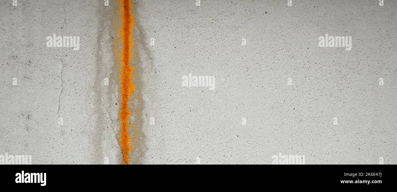 Rust stain on plaster on beige and white concrete wall, rough wall ...