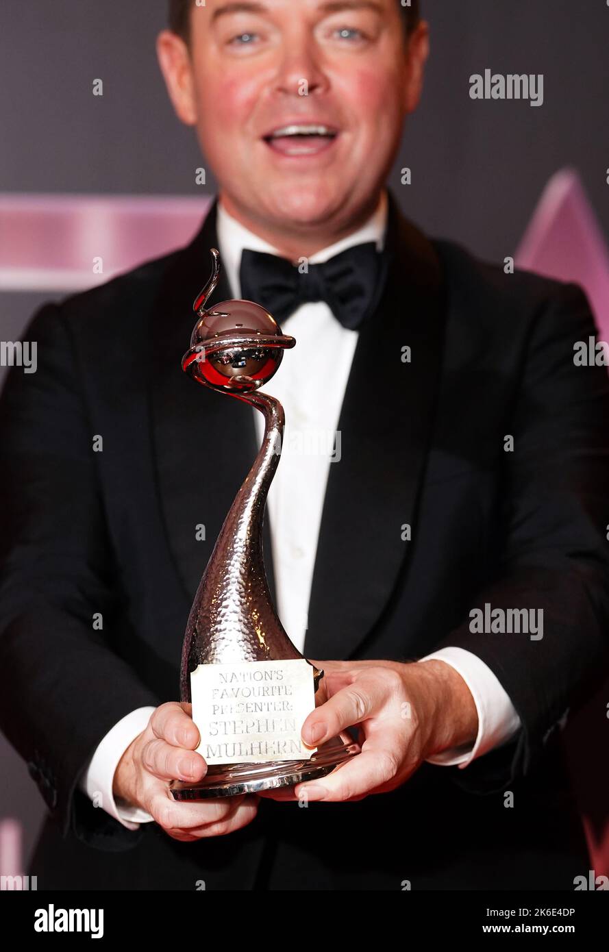 Stephen Mulhern holds up a novelty trophy plaque with his name on in ...