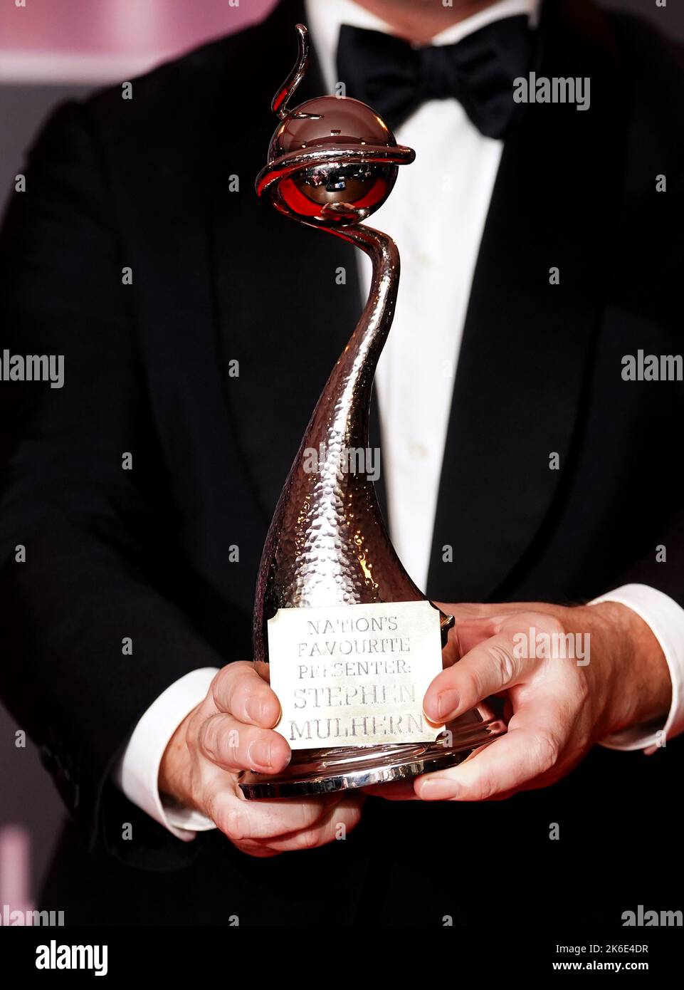 Stephen Mulhern holds up a novelty trophy plaque with his name on in ...