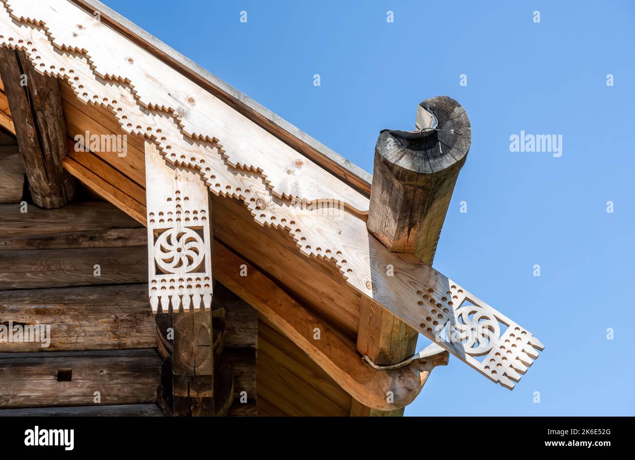 Traditional wooden handmade carved decorations on the roof of a wooden ...