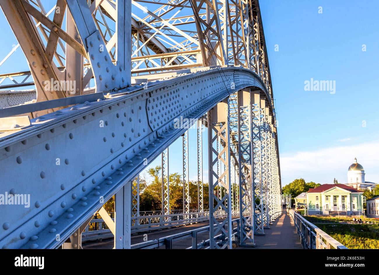 Steel arch bridge across the Msta river in summer sunny day. Built in ...