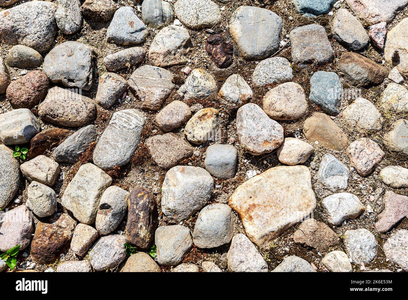 Rough cobblestone pavement on the road as creative background texture ...