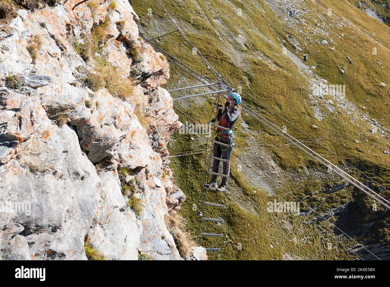 Climber Ascends The 540° Grade Ladder On The Gemmiwand Via Ferrata ...