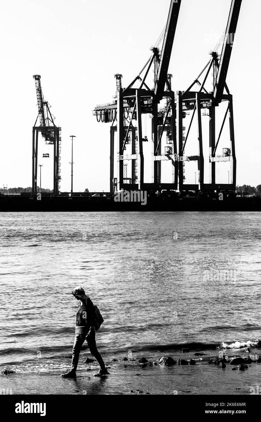 A vertical grayscale shot of industrial machinery across the Hafen ...
