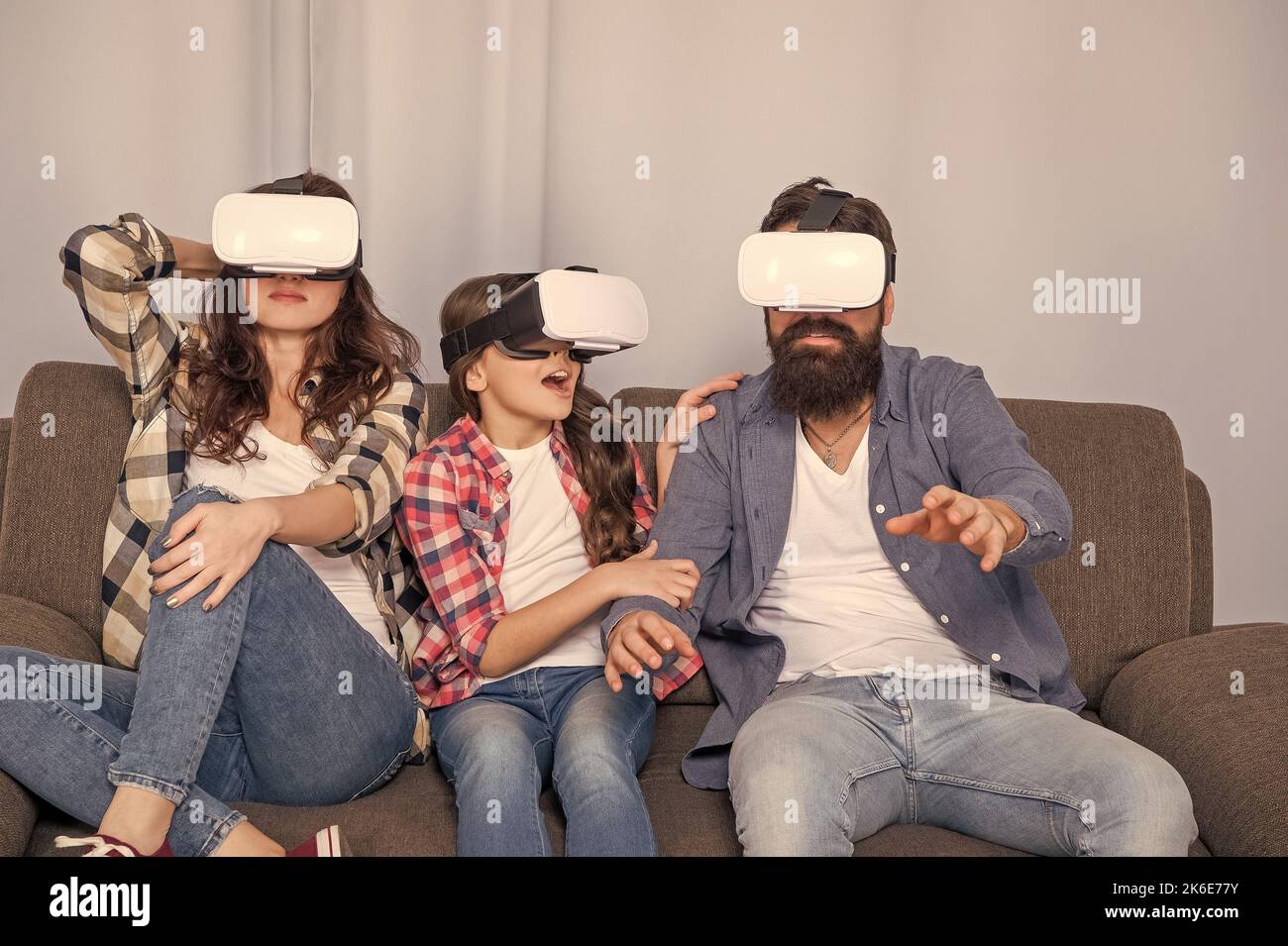 modern life. father mother and child VR glasses. virtual reality family ...