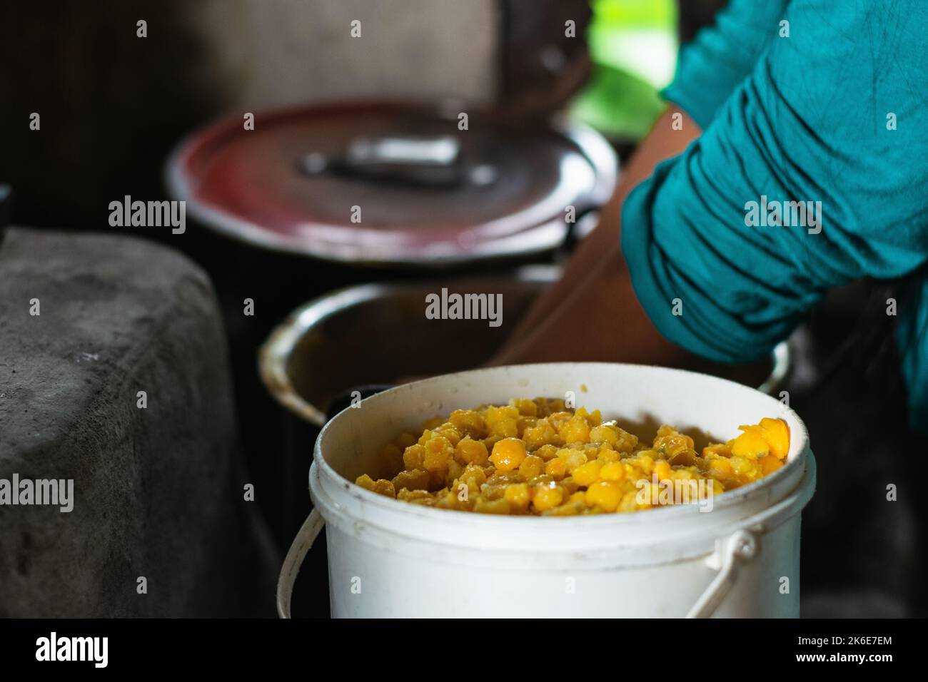 close-up of a peasant girl taking out the cooked threshed corn for the ...