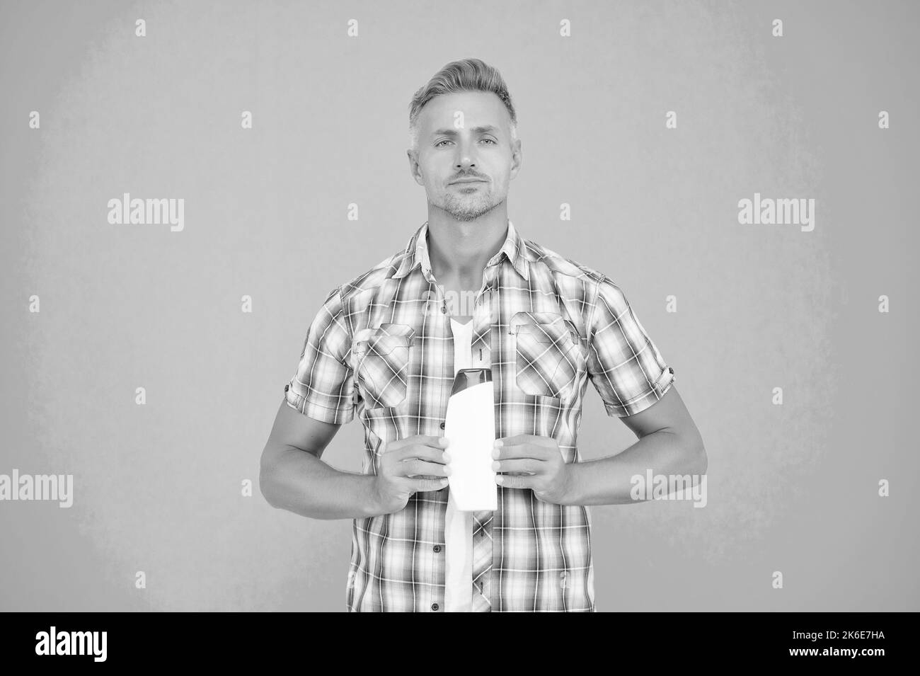 Skincare for your scalp. Man hold shampoo bottle blue background. Hair ...