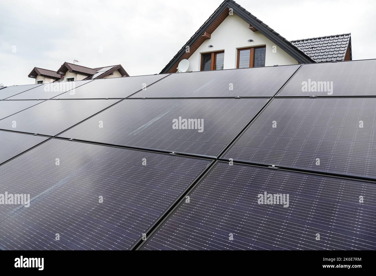 Large solar panels next to houses in residential suburb Stock Photo - Alamy
