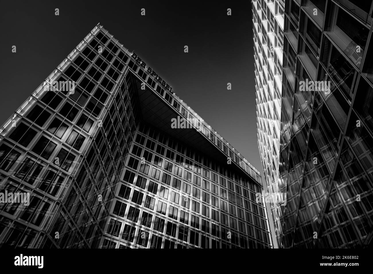 A low angle greyscale shot of modern buildings with beautiful ...