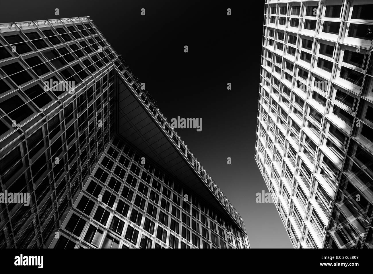 A low angle greyscale shot of modern buildings with beautiful ...