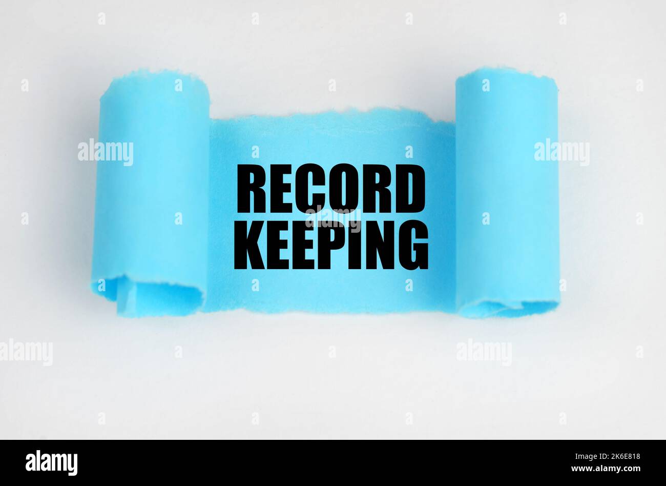 On a white surface, a blue scroll of paper with the inscription ...