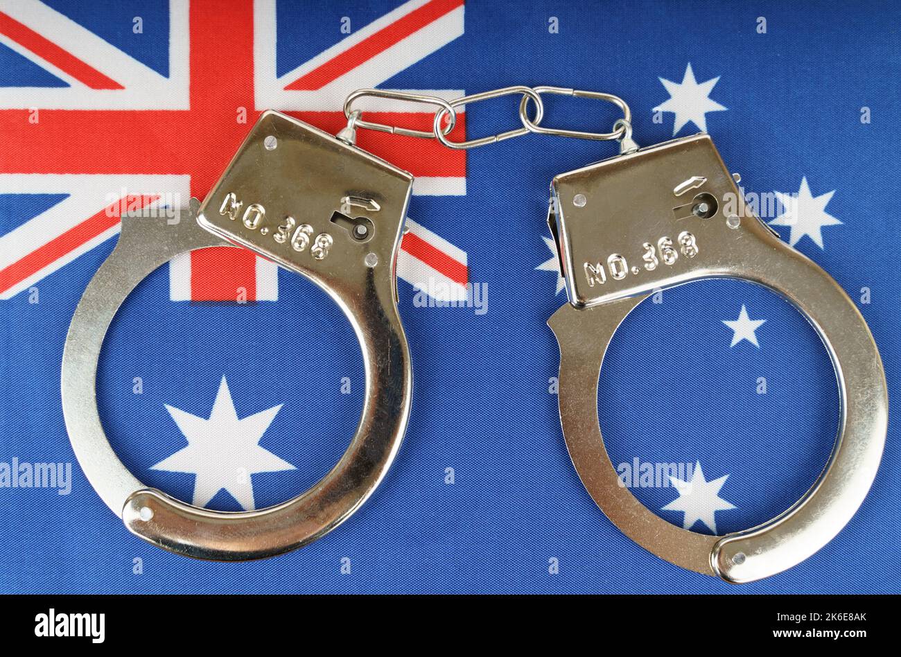 The concept of law and crime. There are handcuffs on the flag of ...