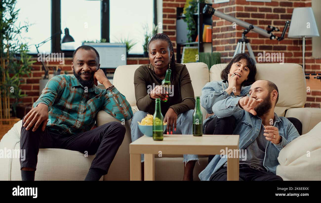 Diverse people having fun watching movie together, enjoying action film ...