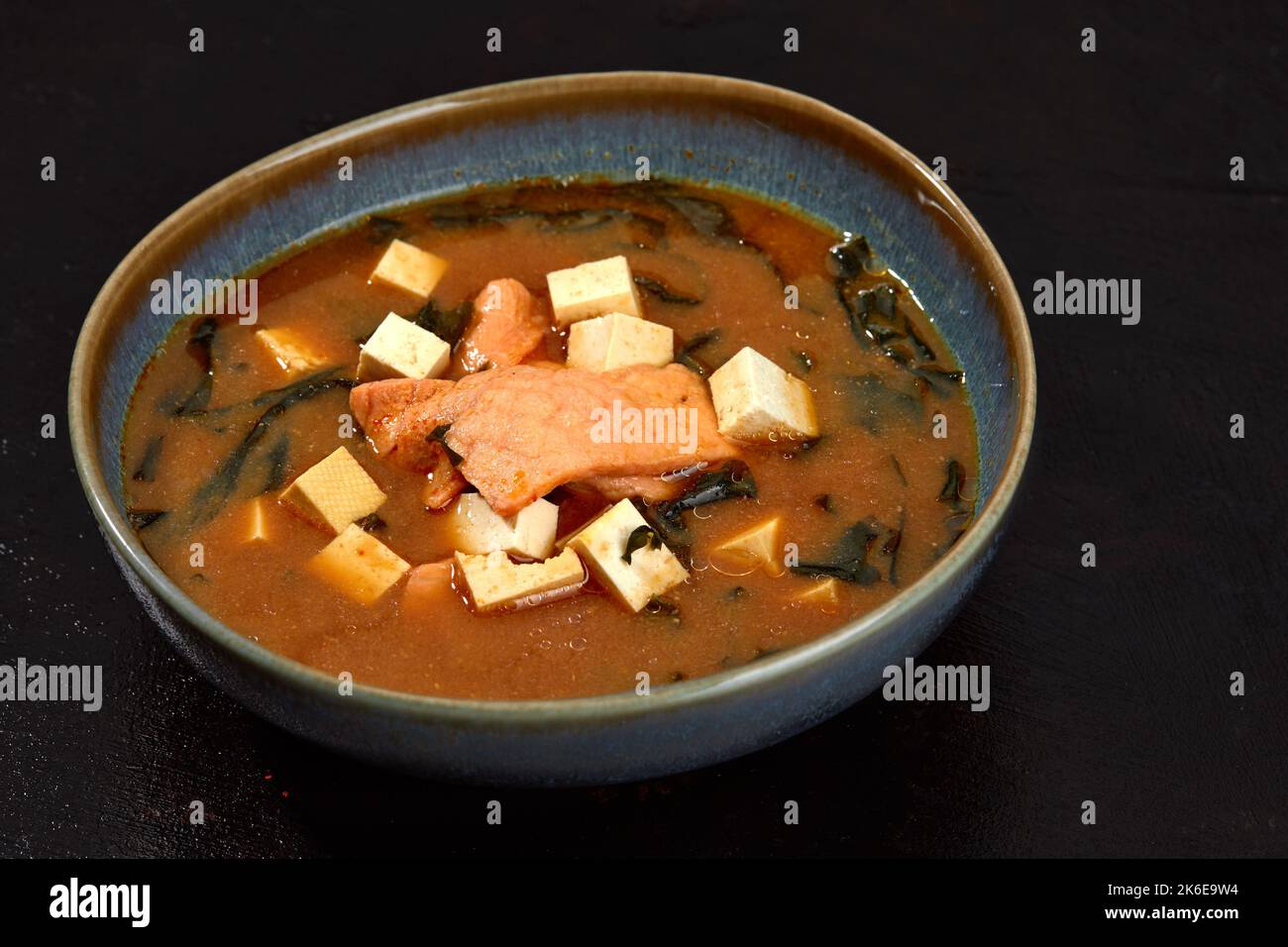 Japanese miso soup in a gray bowl on the black table. horizontal view ...