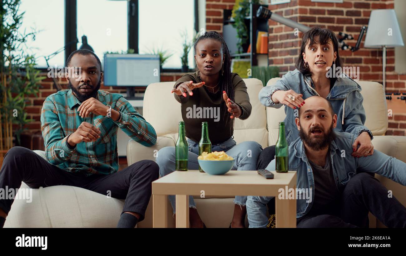Angry football fans watching game match on television, losing ...