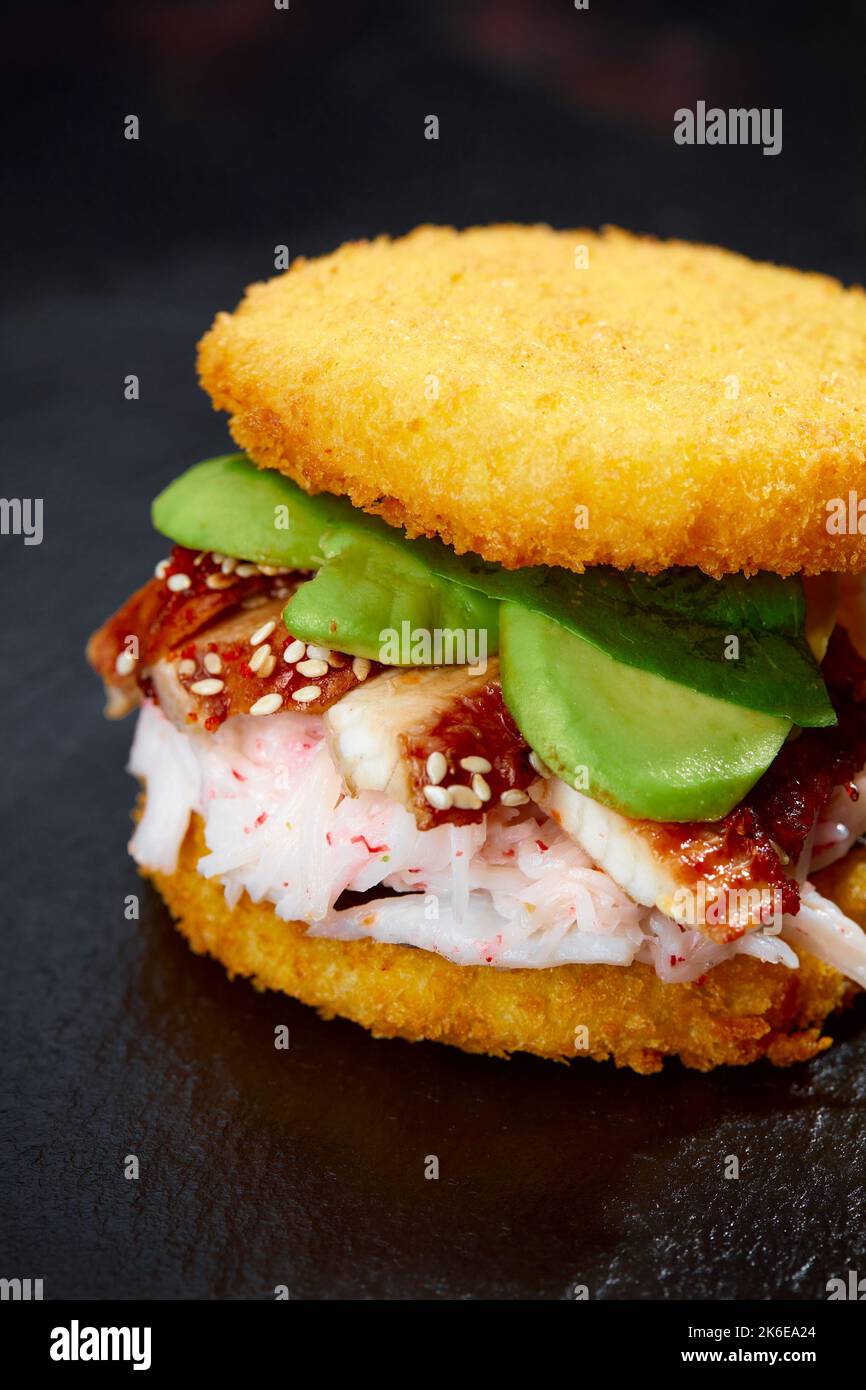 Pan-Asian cuisine concept. Japanese sushi burger made from rice bread ...