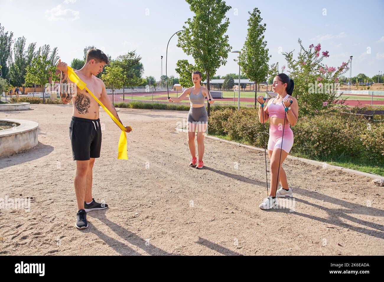 three friends playing sports in the park Stock Photo - Alamy