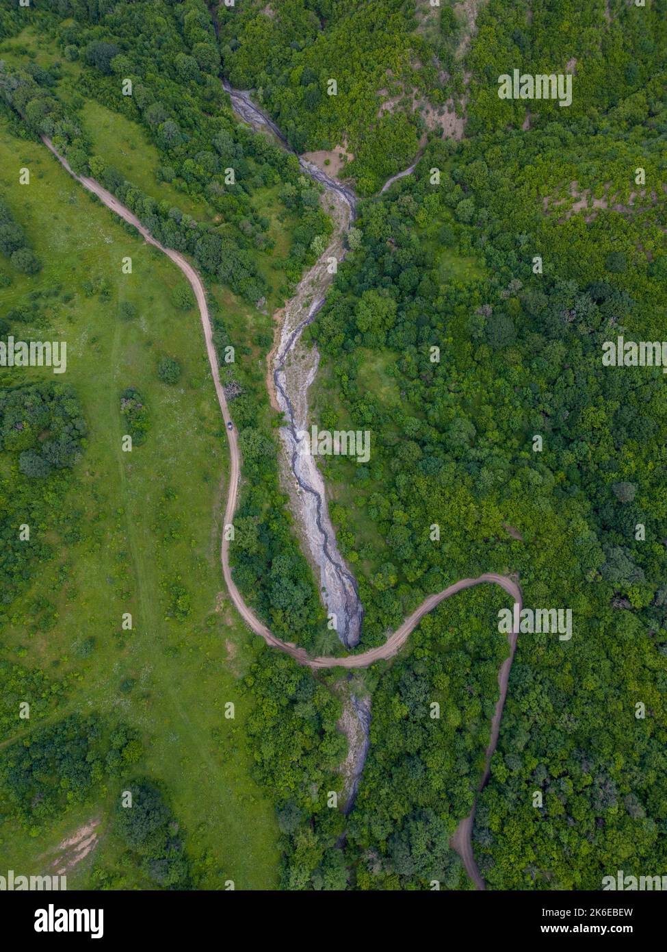 An aerial view of a road and river in the middle of a forest Stock ...