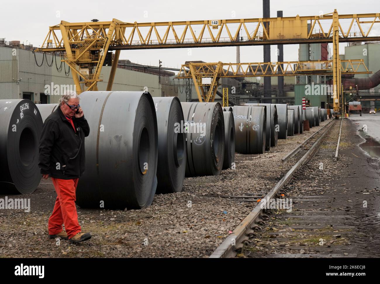 An employee at ArcelorMittal Dofasco walks as they manufacture slabs of steel hot roll coils in ...