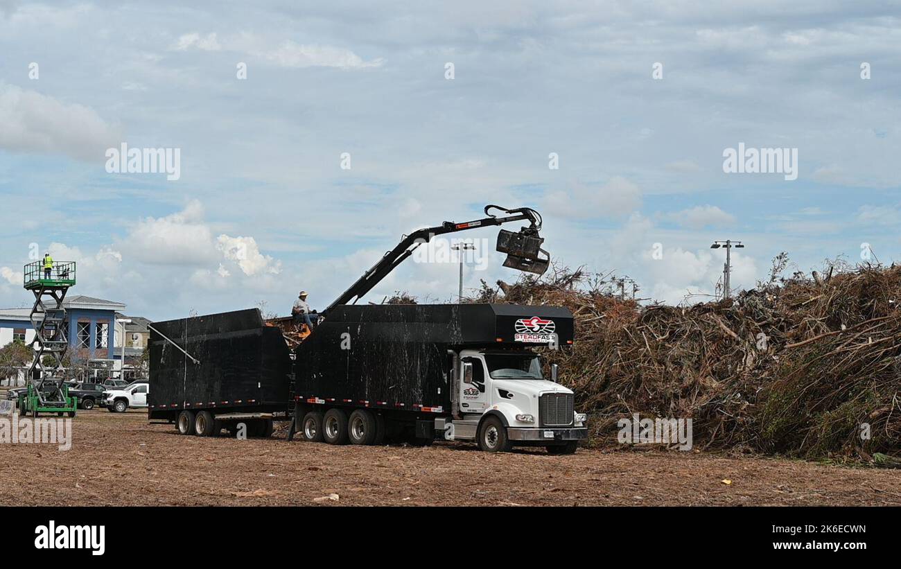 A construction vehicle moves Hurricane Ian storm debris in Lee County ...