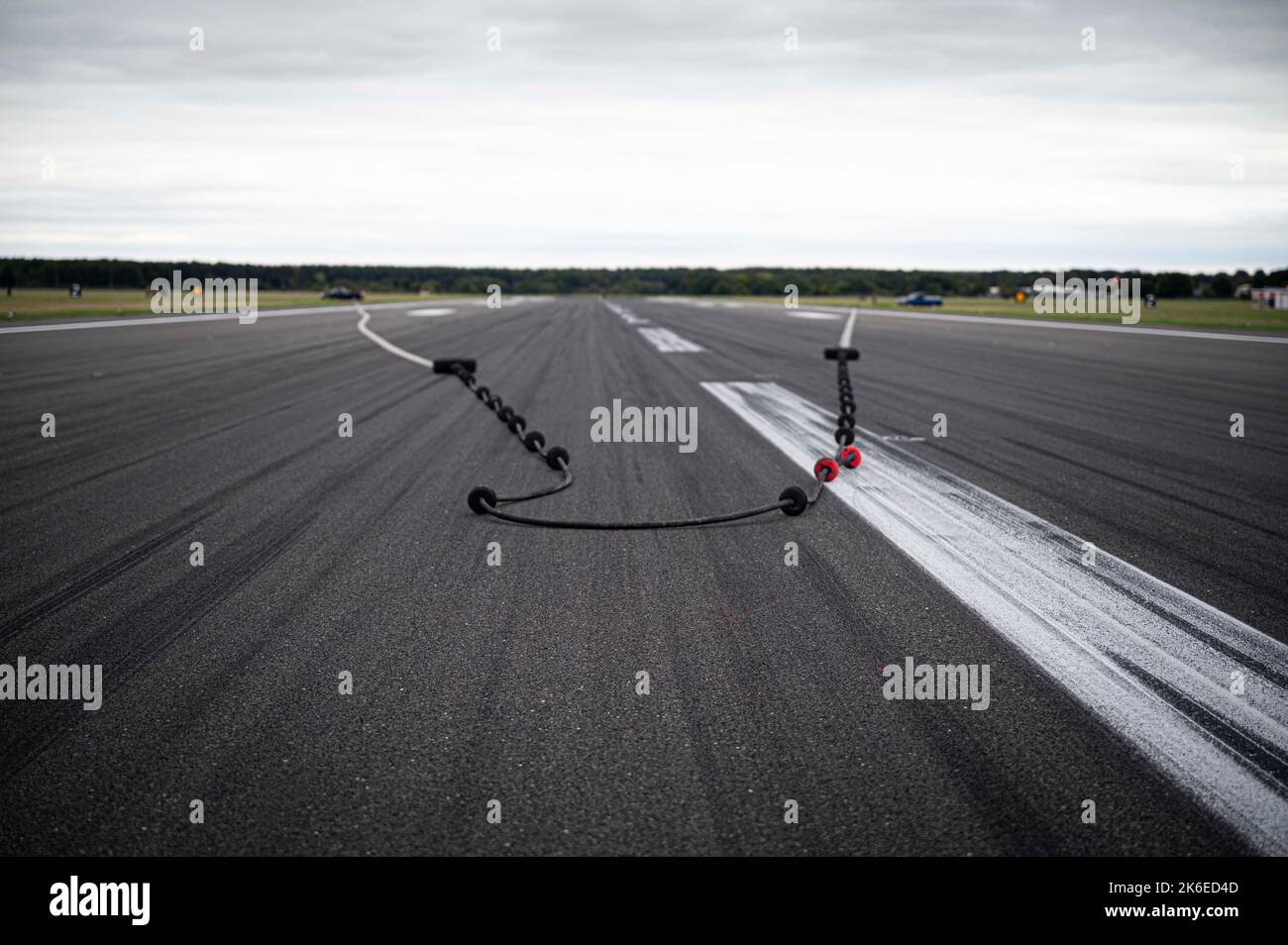 A barrier aircraft arresting landing system sits on the flightline ...