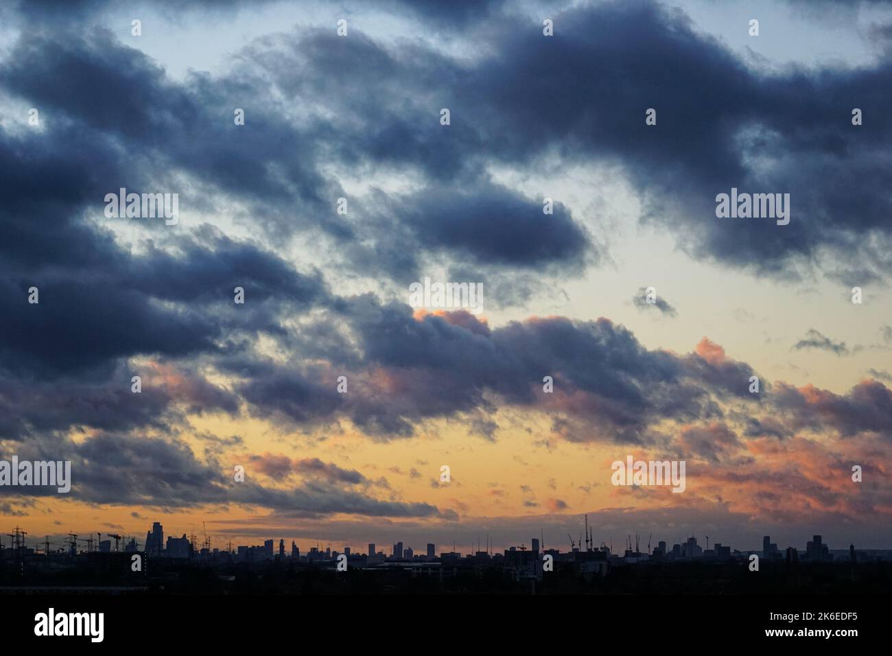 Sunset sky over a silhouette of city buildings Stock Photo - Alamy