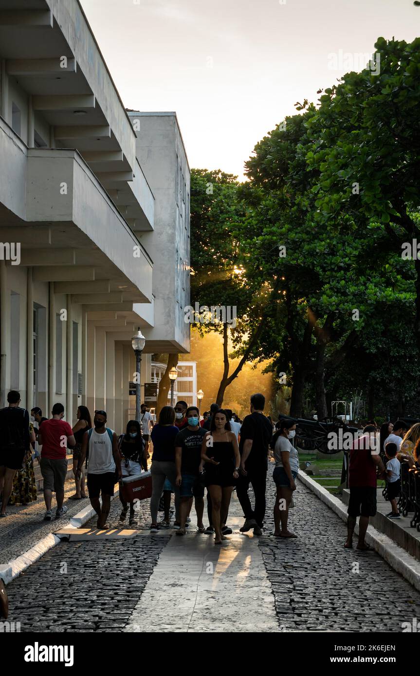 Crowd of tourists walking around on the outdoor cobblestone path of ...