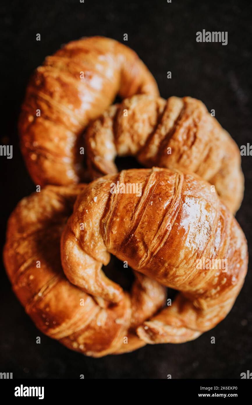 medialunas, argentinian sweet croissant over a black backdrop. copy ...