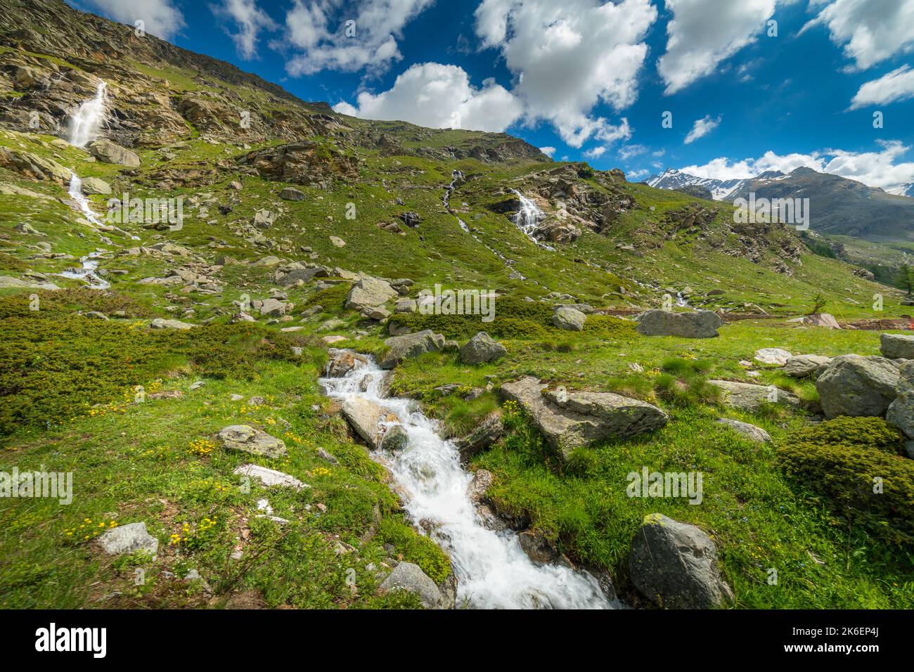 Ethereal waterfall and alpine meadows at springtime, Gran Paradiso Alps ...