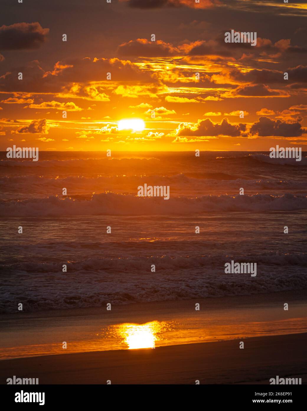 Beautiful vertical photo of sunset at the beach on a cloudy day in ...