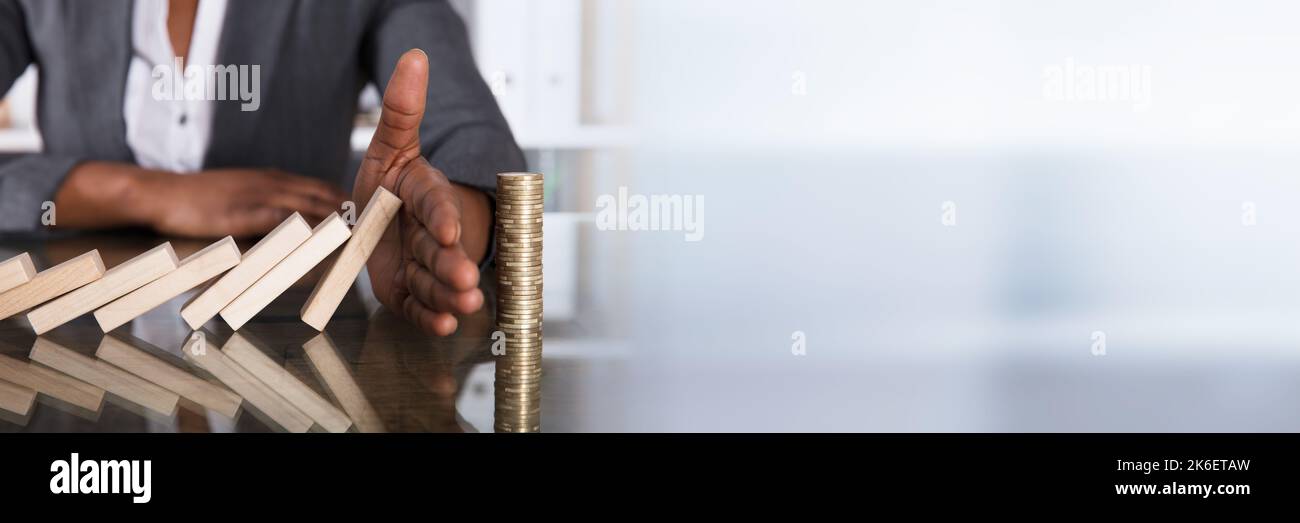 African American Hand Stopping Falling Domino Blocks Stock Photo - Alamy